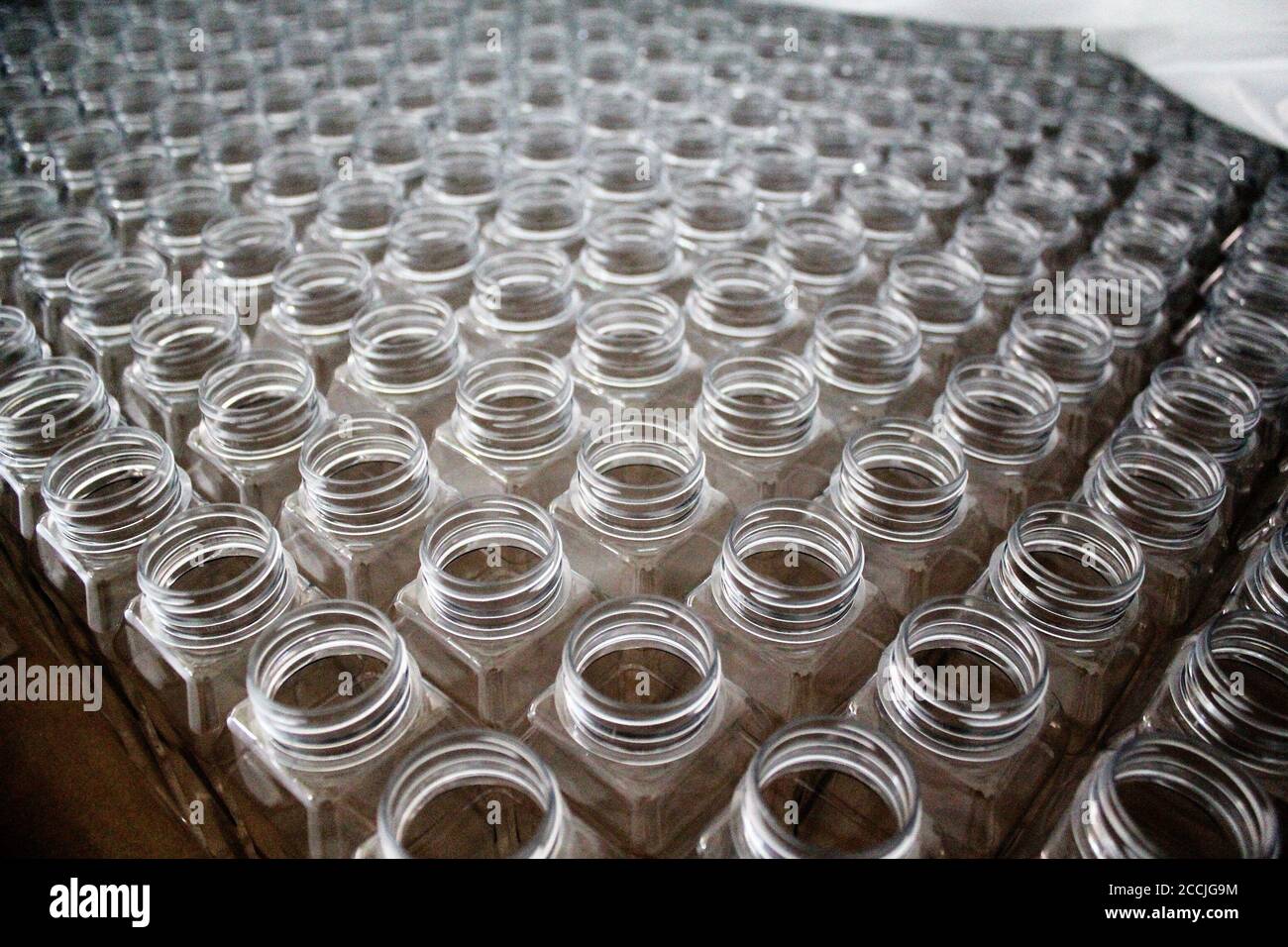 Clean plastic bottles stacked in a factory Stock Photo - Alamy
