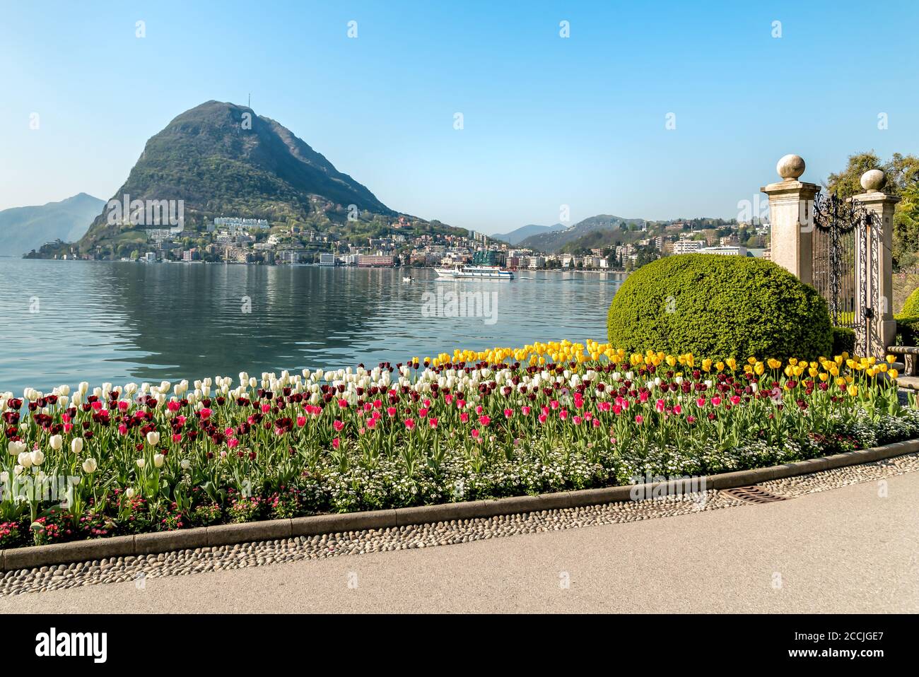Landscape of Lake Lugano with colorful tulips in bloom from Ciani Park ...