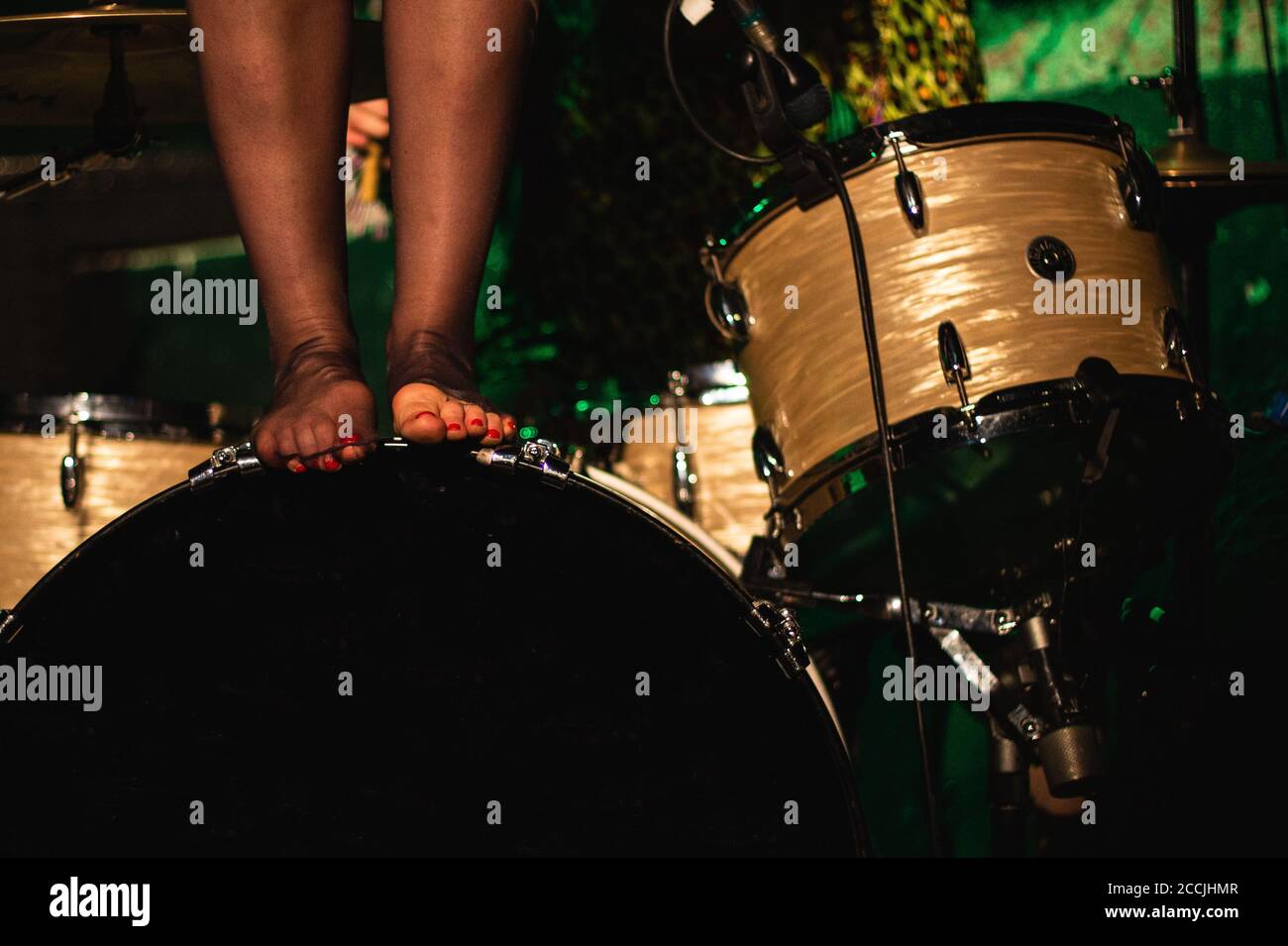 Girl's feet on top of a drum sets in stage Stock Photo - Alamy
