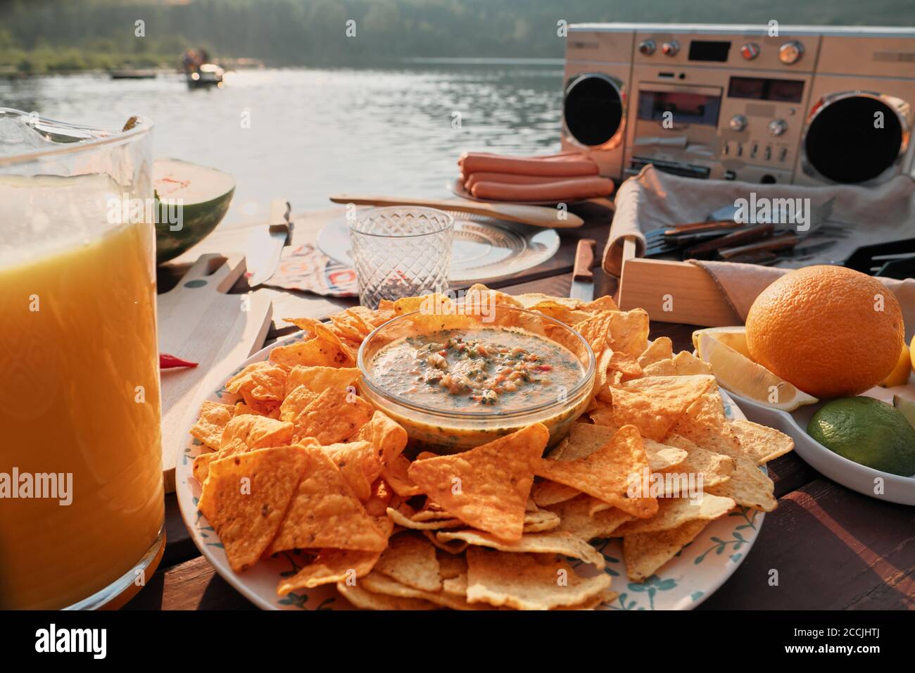 Close-up of chips with sauce on the table with other snacks prepared ...