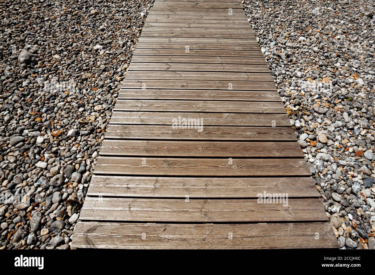 Pebble beach wooden deck close-up clean view image Stock Photo - Alamy