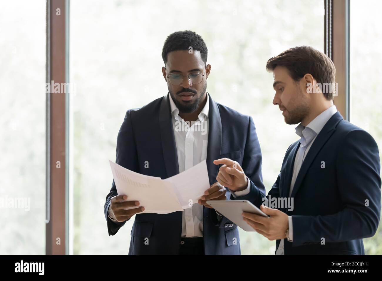 Caucasian manager explaining african client deal details Stock Photo ...