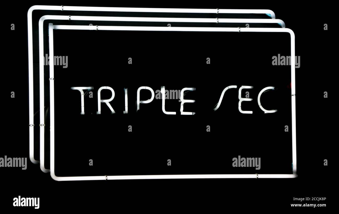 Triple sec white neon light on black background Stock Photo - Alamy