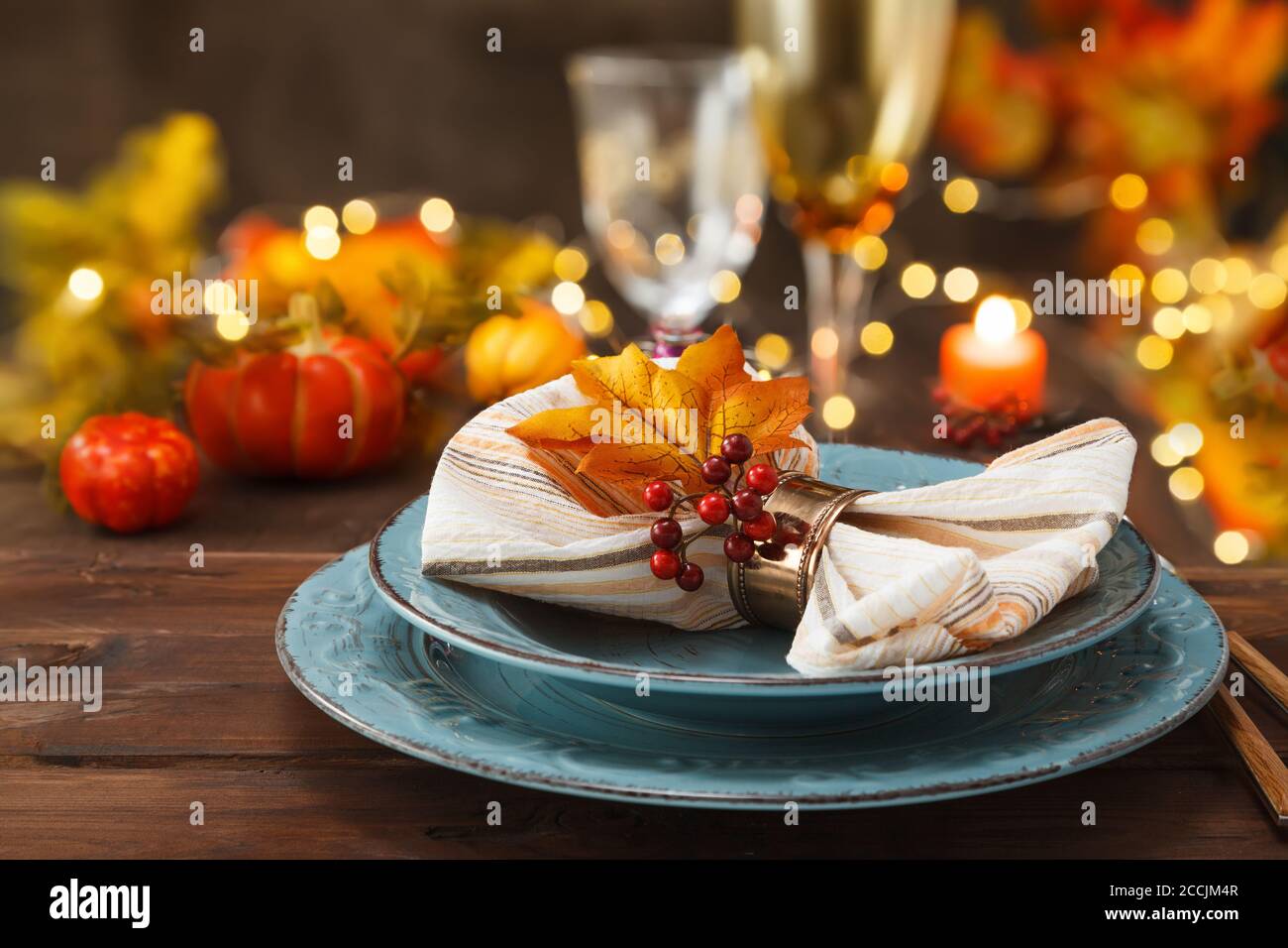 Thanksgiving autumn place setting with cutlery and arrangement of ...
