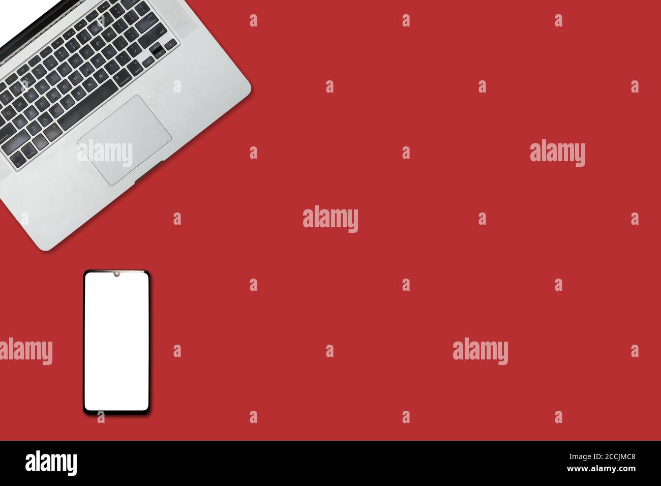 Open laptop with white smartphone. All with isolated screen on red ...