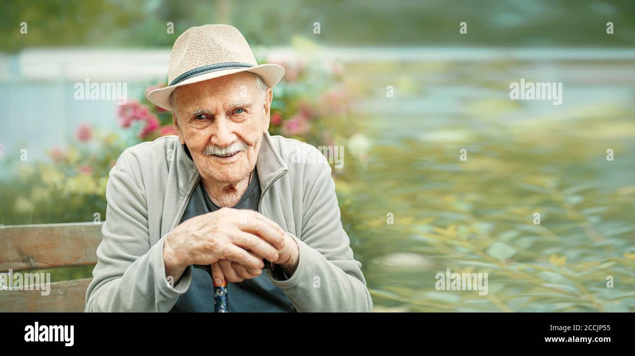 Portrait of a smiling and confident senior 87 years old cute in a hat ...