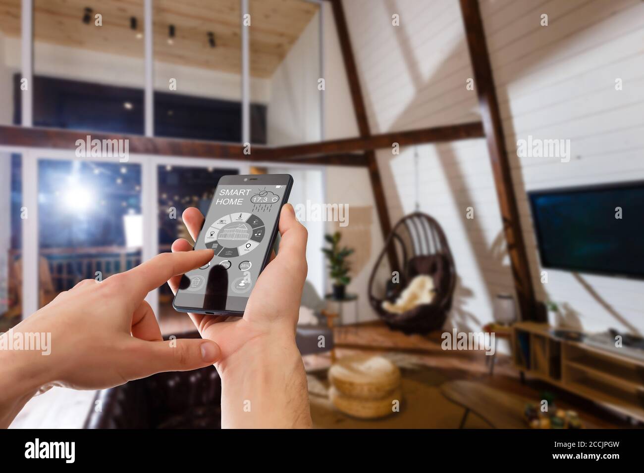 smart house, home automation, device with app icons. Man uses his ...
