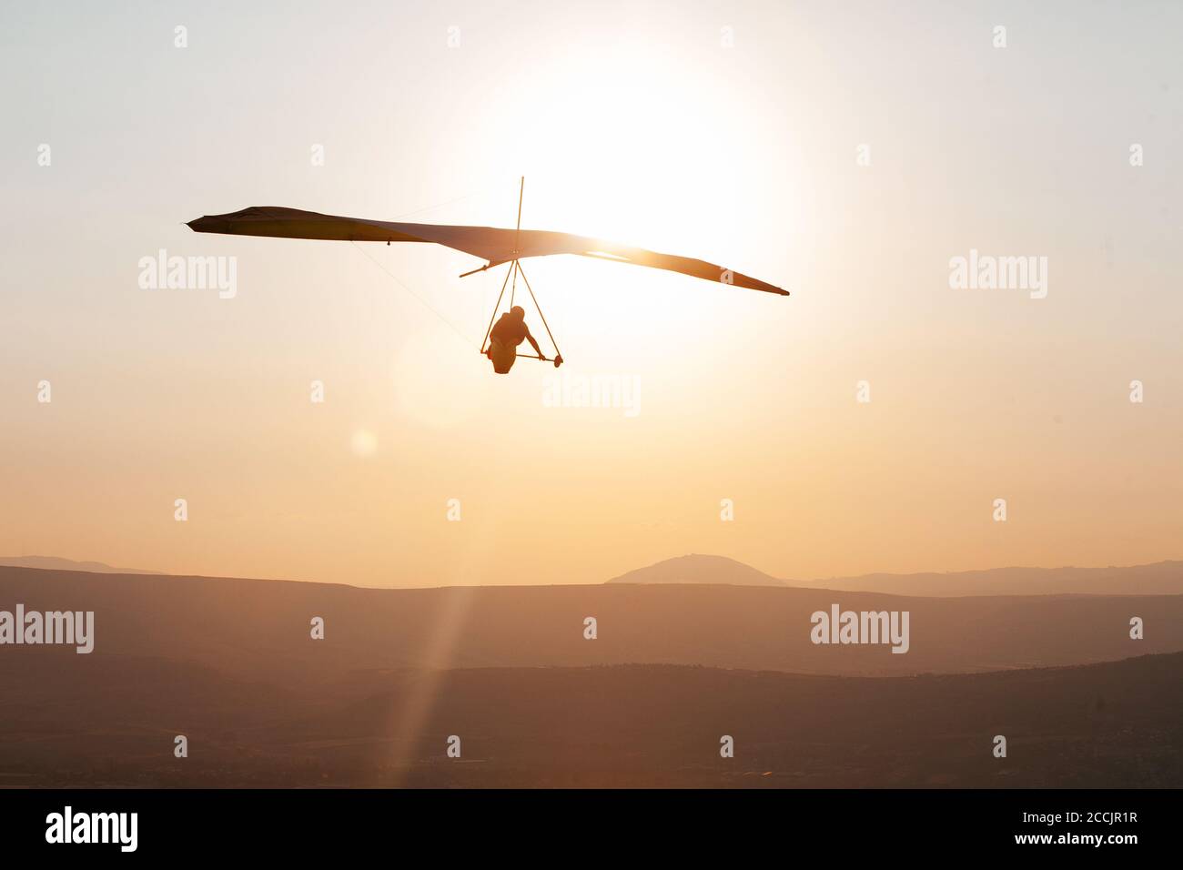 Hang-glider flight in sky in sunset time over the Galilean hills, Mevo ...