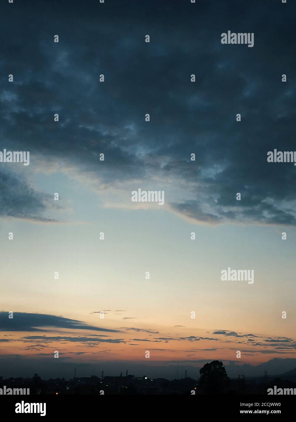 Dark clouds above sunset horizon Stock Photo - Alamy