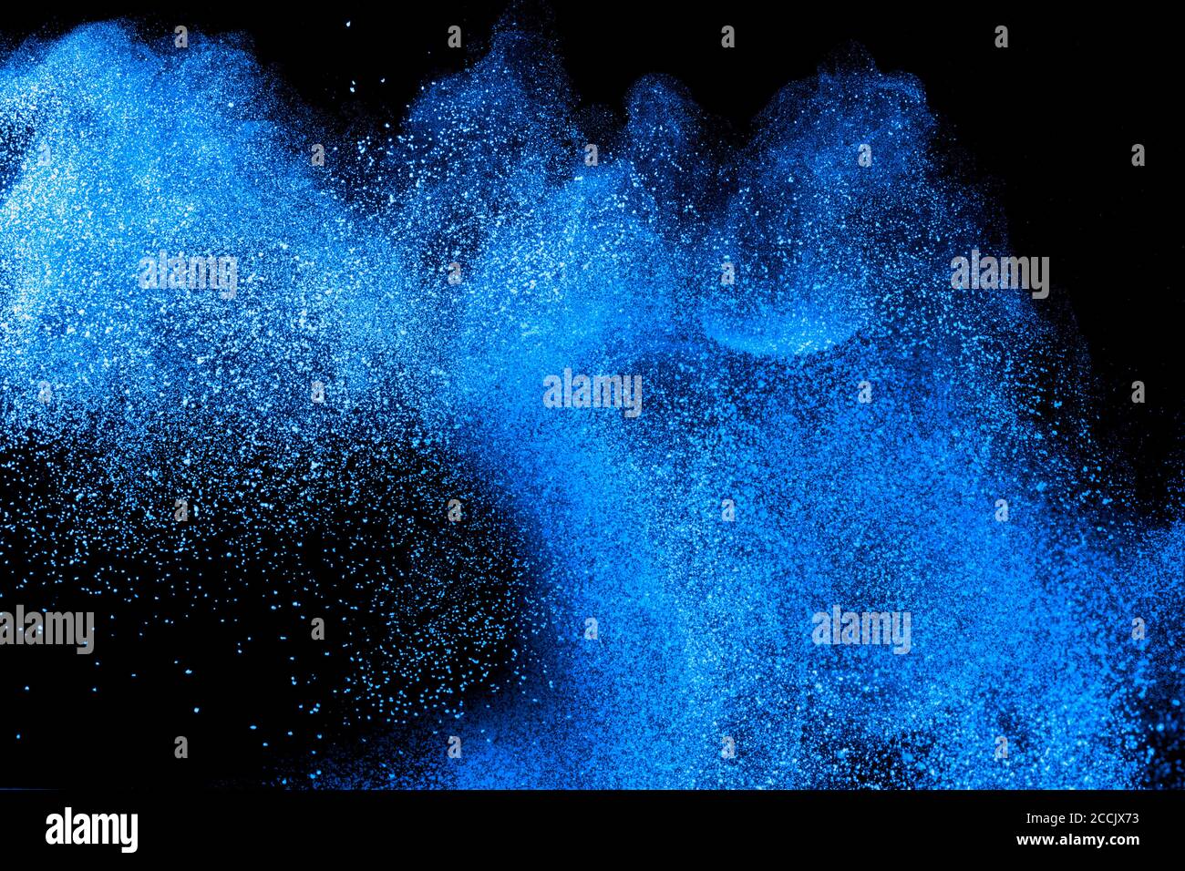 Blue color powder explosion on black background Stock Photo - Alamy