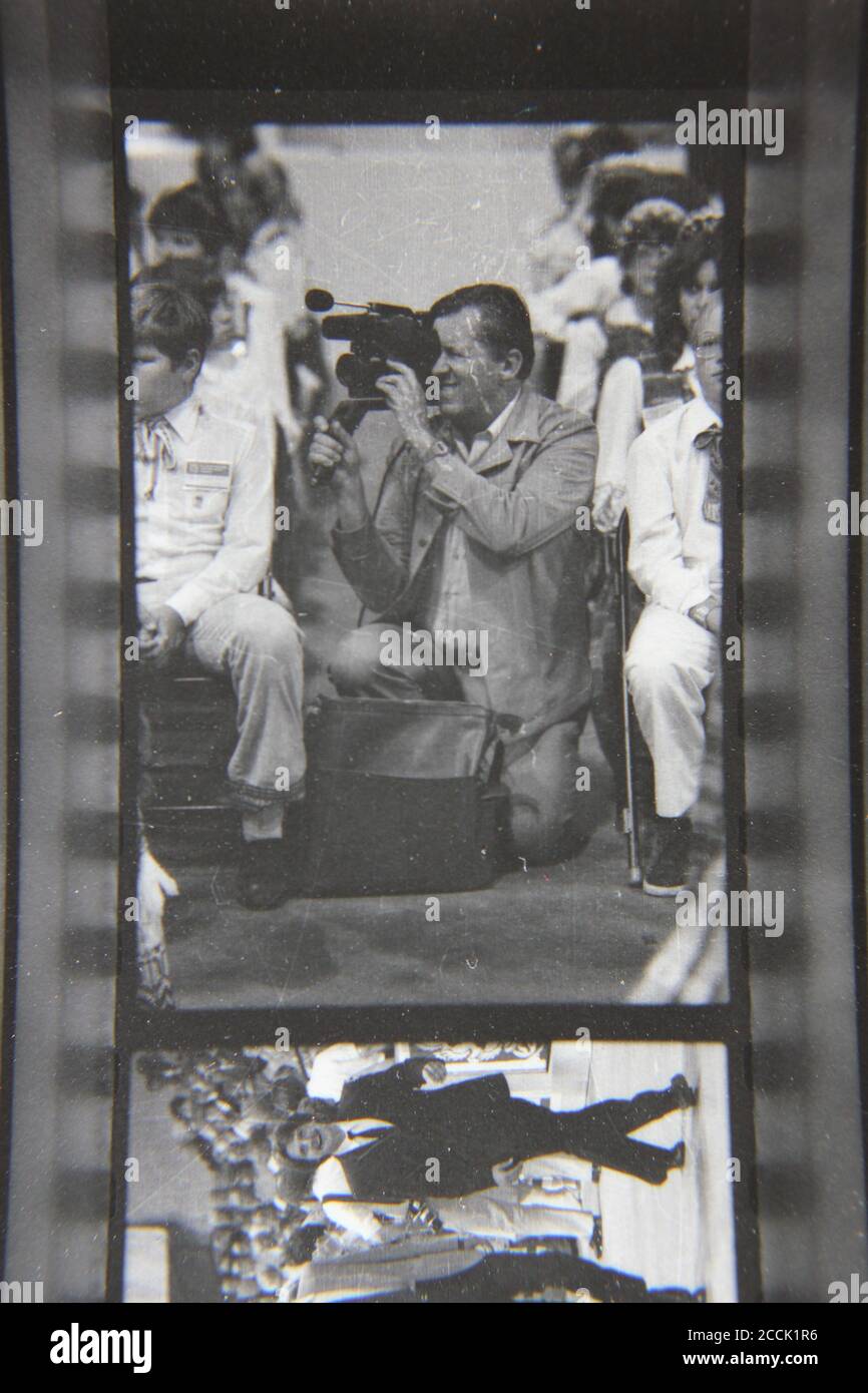 Fine 1970s vintage black and white photography of a man trying to take ...
