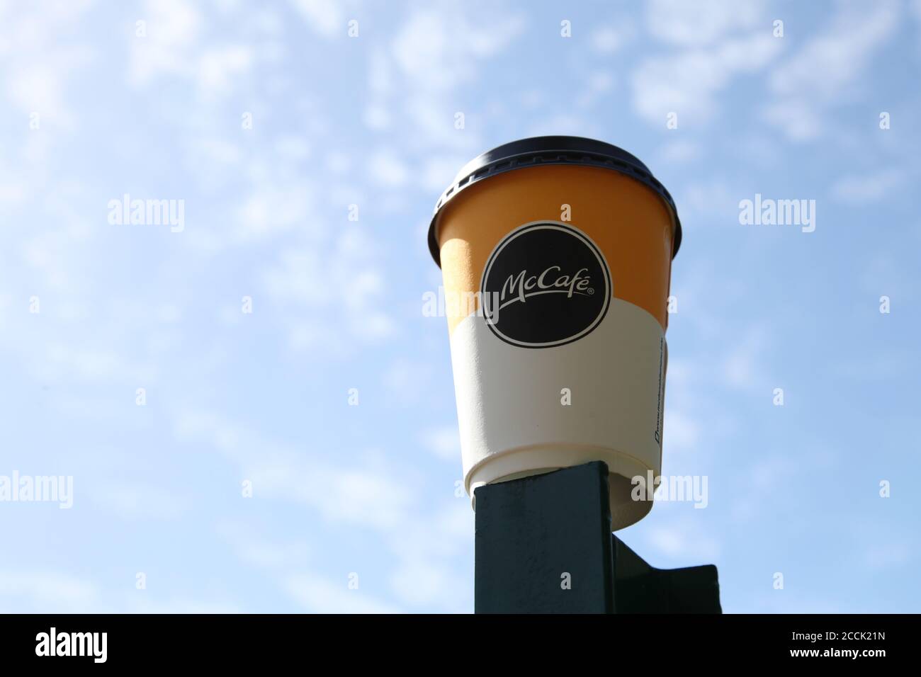 McDonald's McCafe disposable coffee cup on blue sky background, looking ...