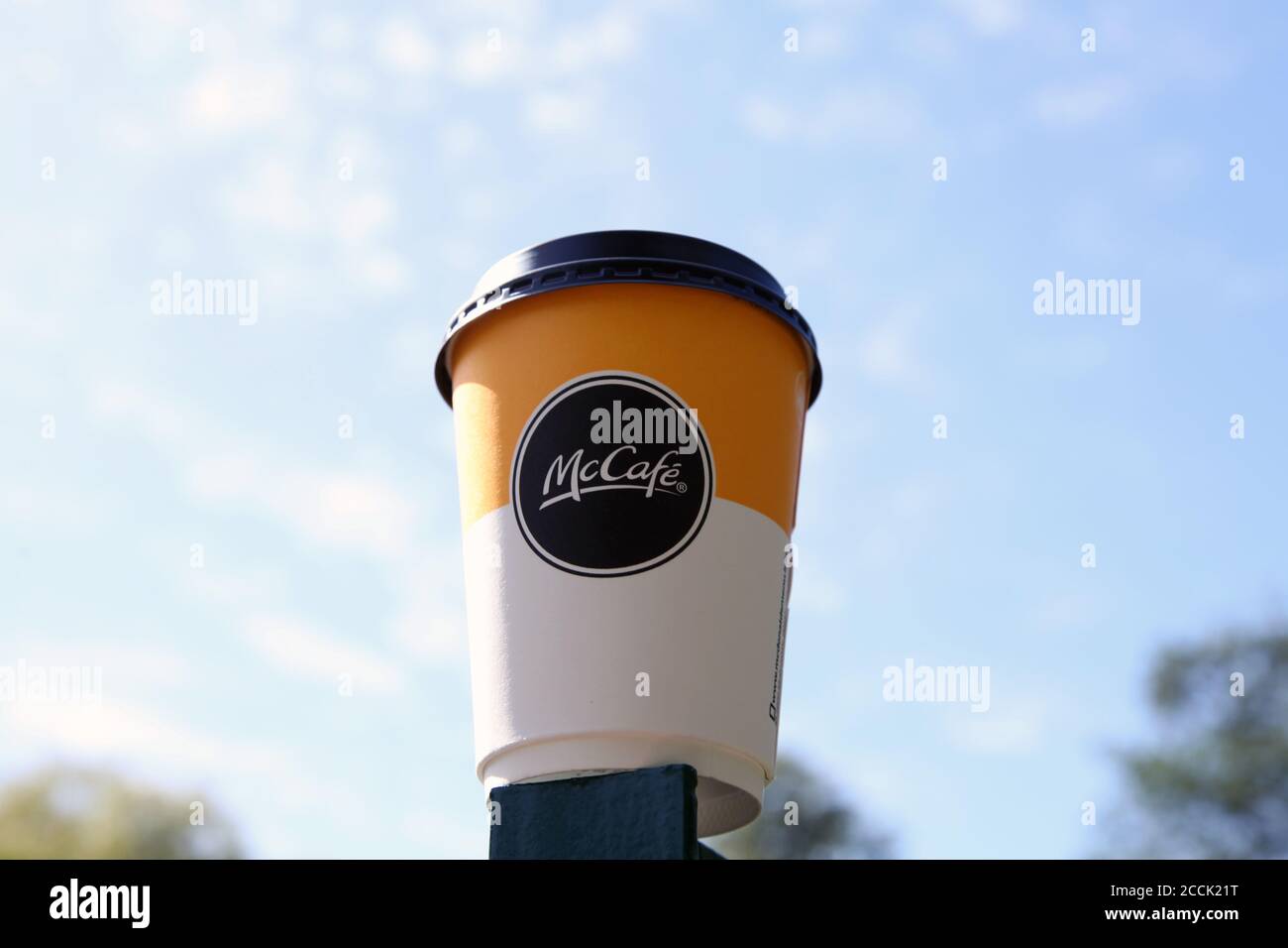 McDonald's McCafe disposable coffee cup on blue sky background, looking ...