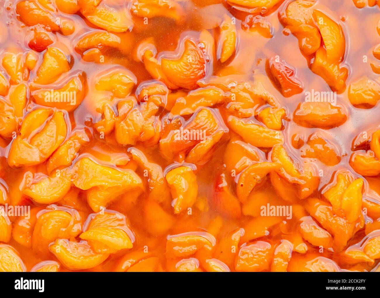 close up orange peach jam texture background. Abstract fruit backdrop ...