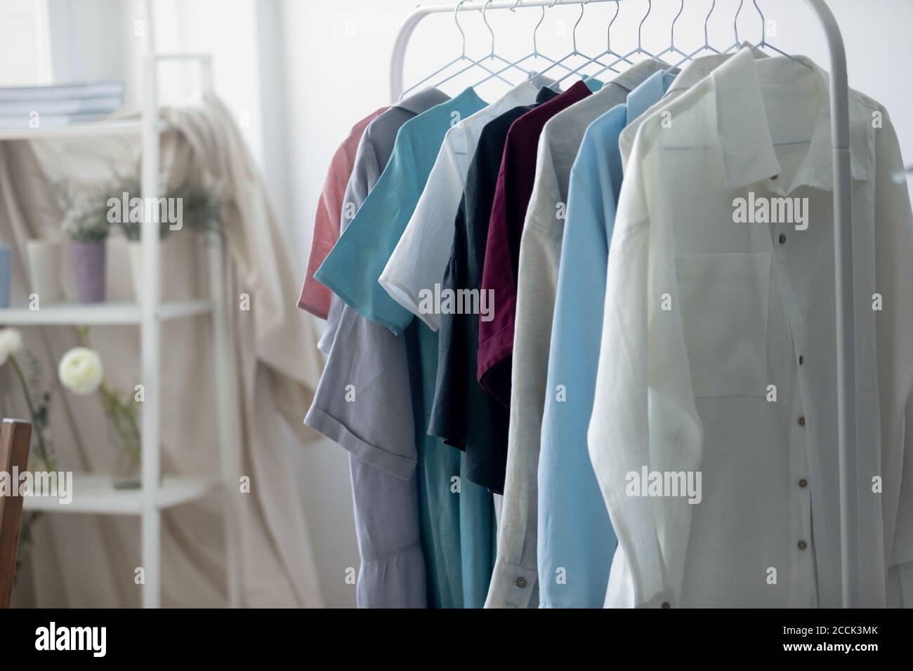 Close up new clothing collection hanging on rack Stock Photo - Alamy