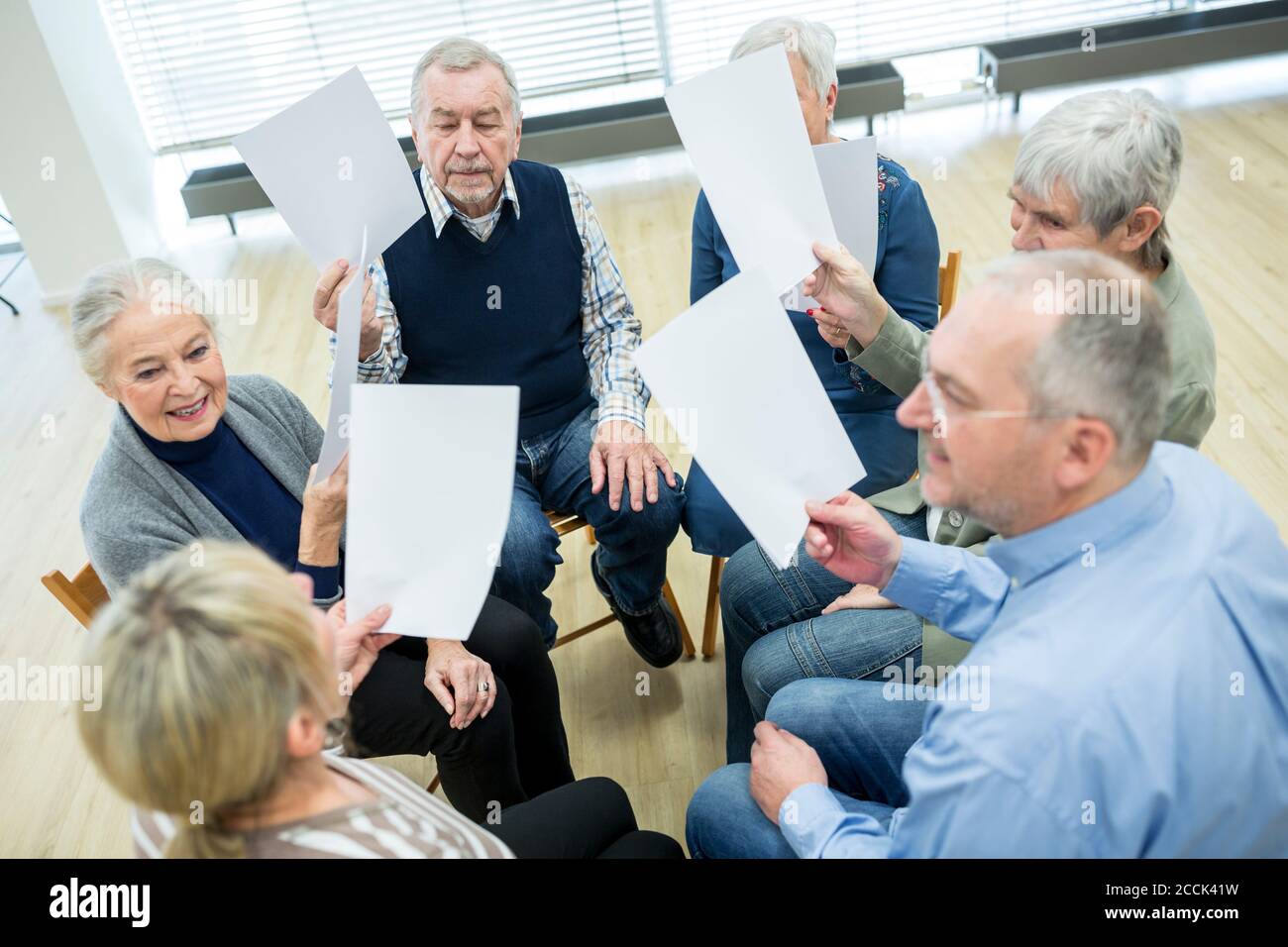 Group of seniors attending therapy group in retirement home hi-res ...