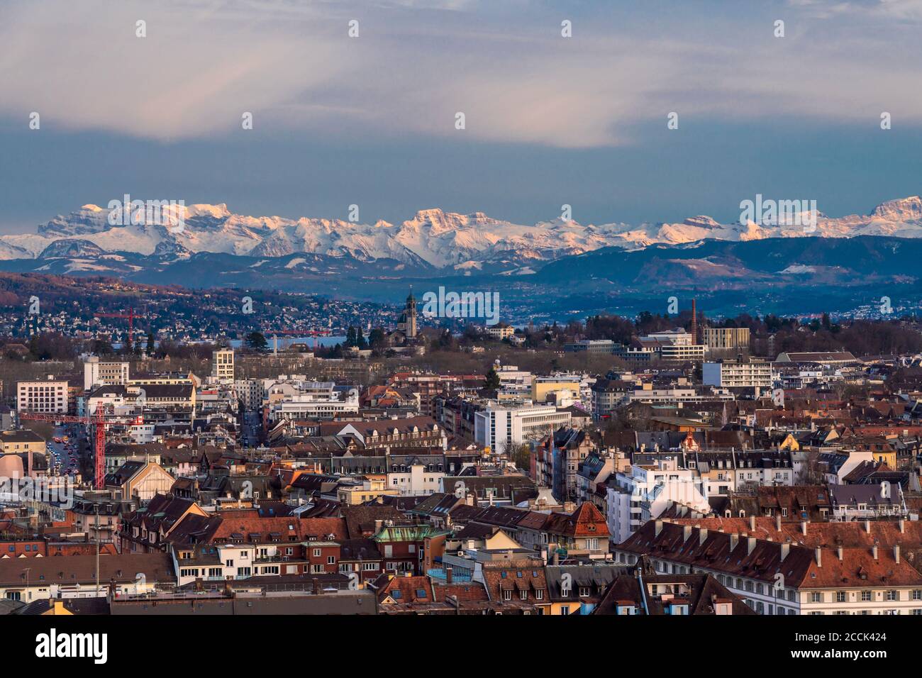 Switzerland, Zurich, Cityscape with snow covered mountains in ...