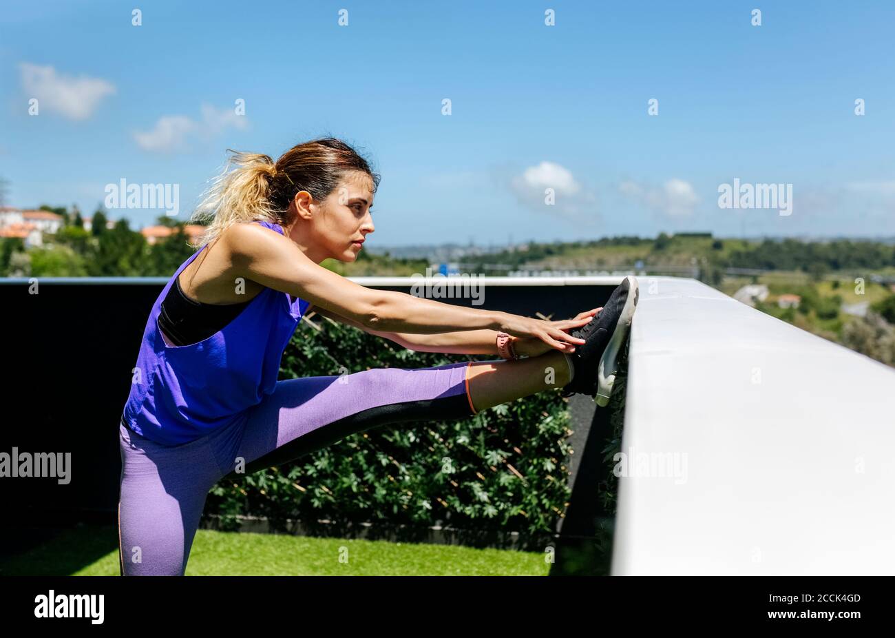 Woman stretching on balcony hi-res stock photography and images - Alamy