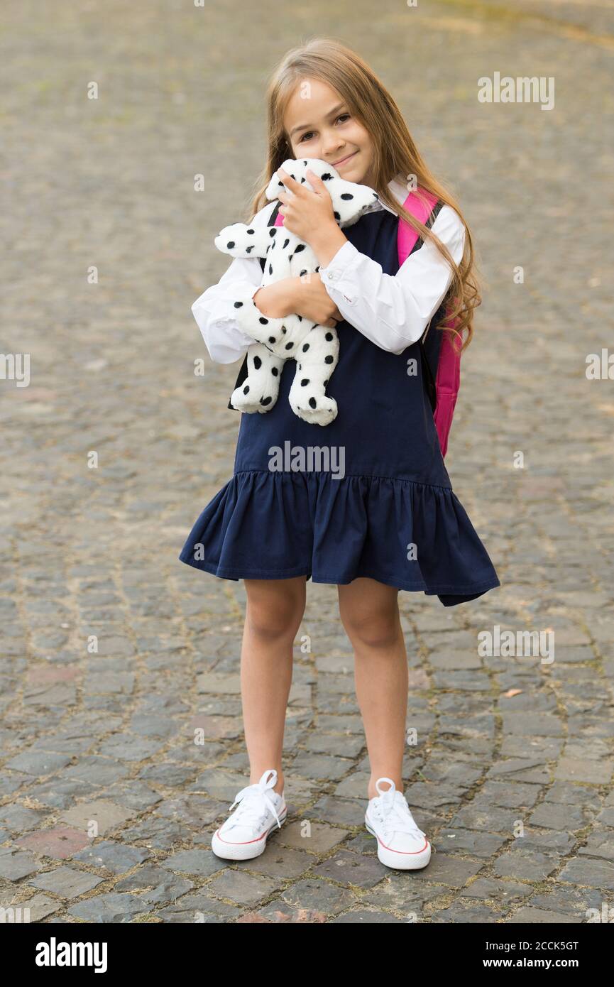 Make time for play. Happy kid hug toy outdoors. Toy friend. Educational ...