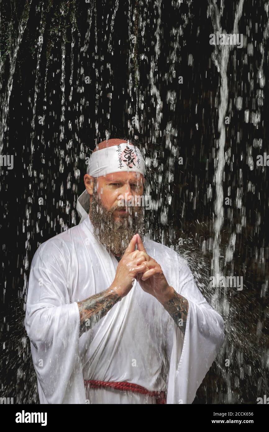 European yamabushi monk doing takigyo waterfall meditation Stock Photo ...
