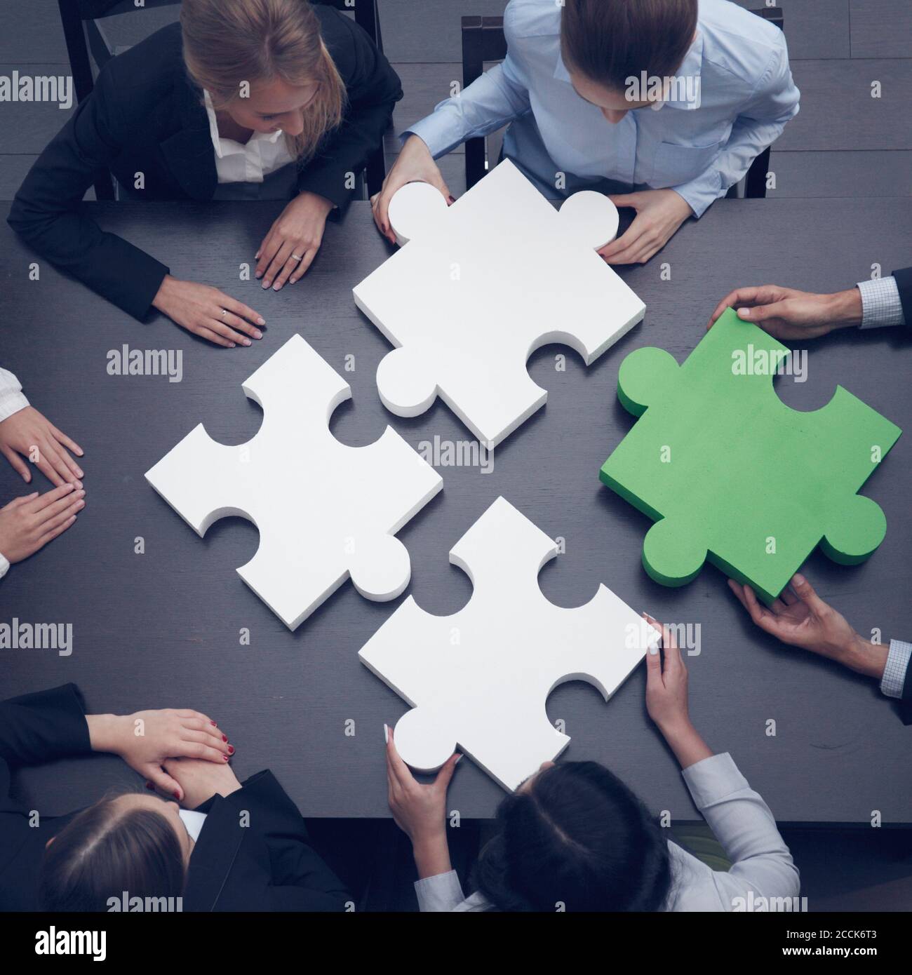 Group of business people assembling jigsaw puzzle, team support and ...