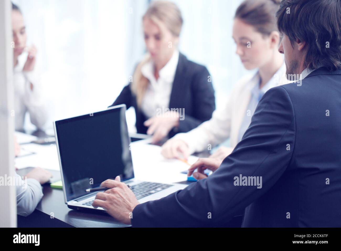 Business people with laptop at meeting in office Stock Photo - Alamy