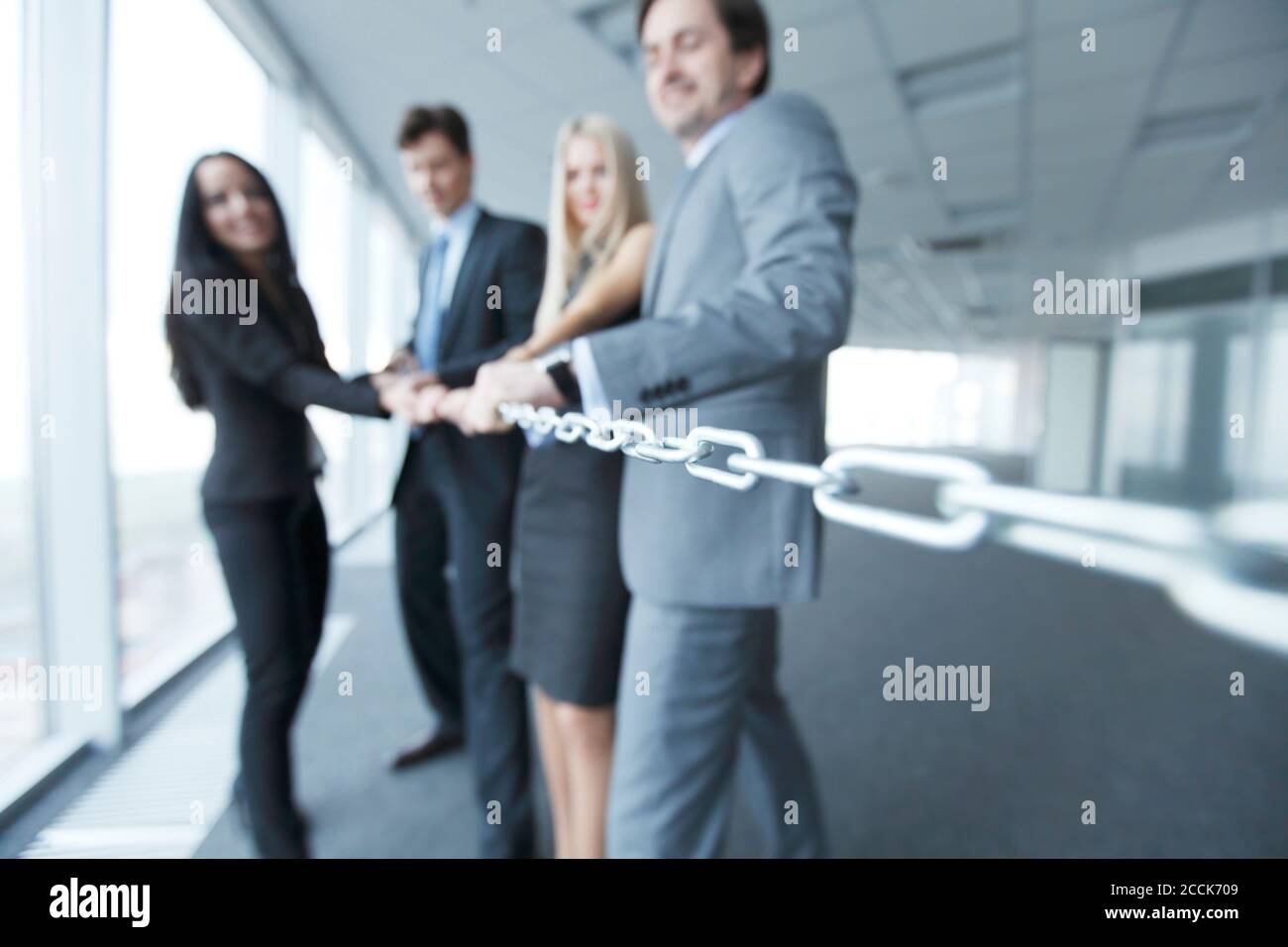 Businessmen pulling chain, teamwork togetherness concept Stock Photo ...