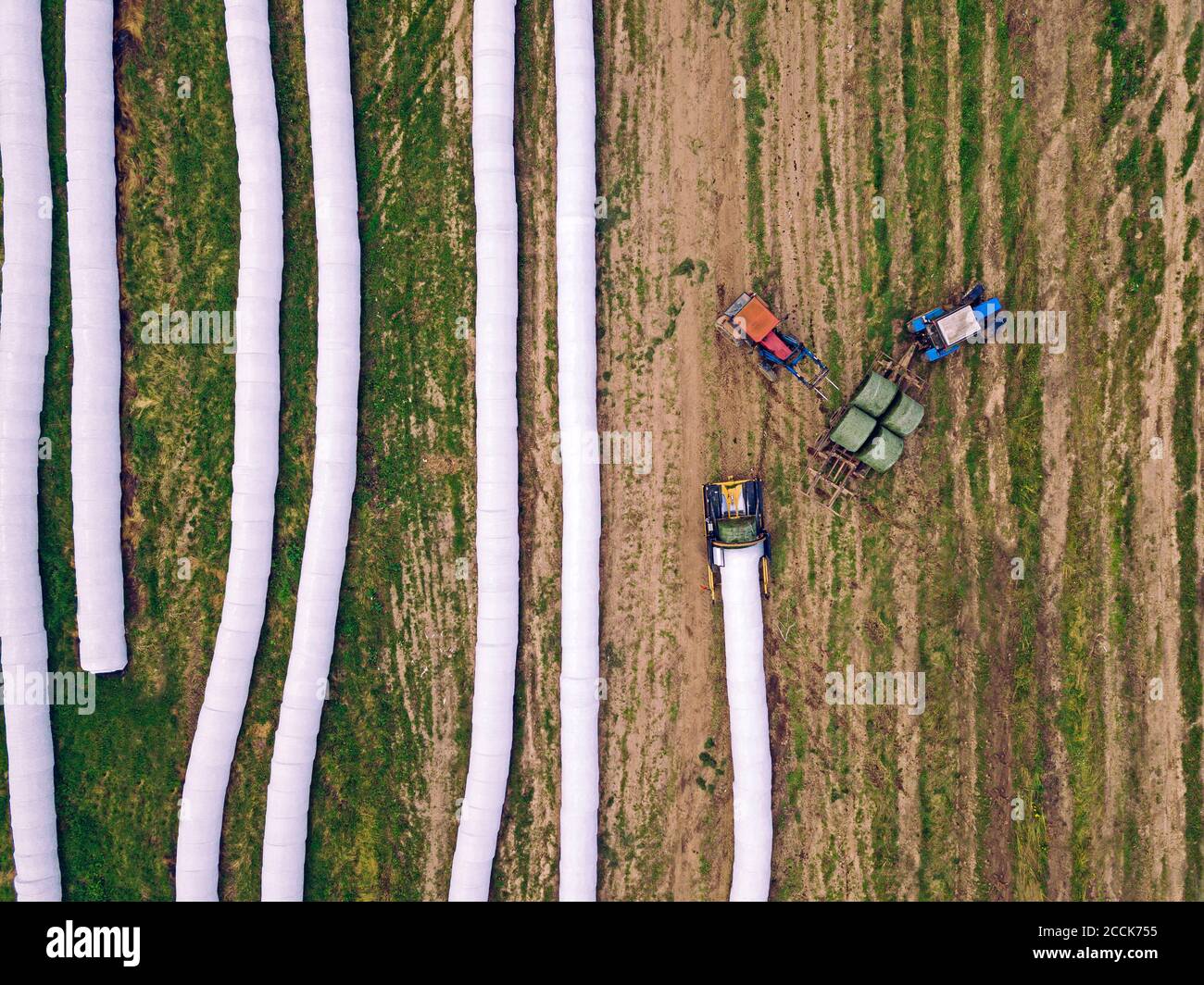 Aerial view of wrapped hay bales drying in field Stock Photo - Alamy