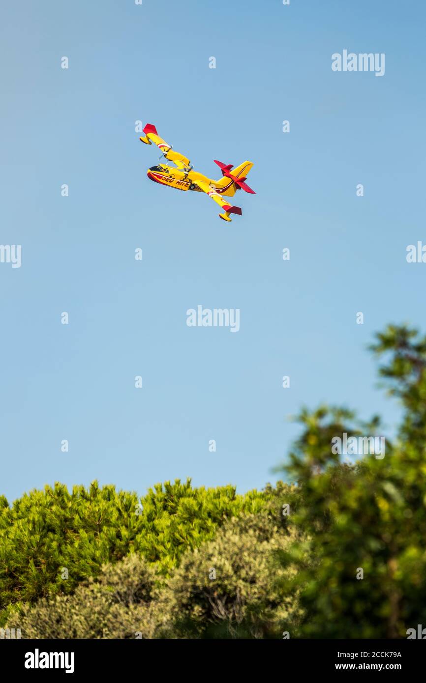 Aerial fire fighting aircraft coming down to pick up water, Corsica ...