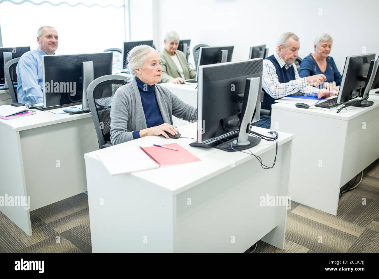Active seniors attending computer course, working on PC Stock Photo - Alamy