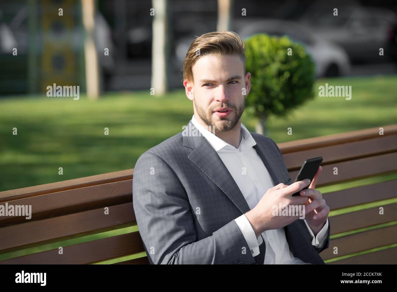 Message concept. Man types message mobile phone. Man in suit ...