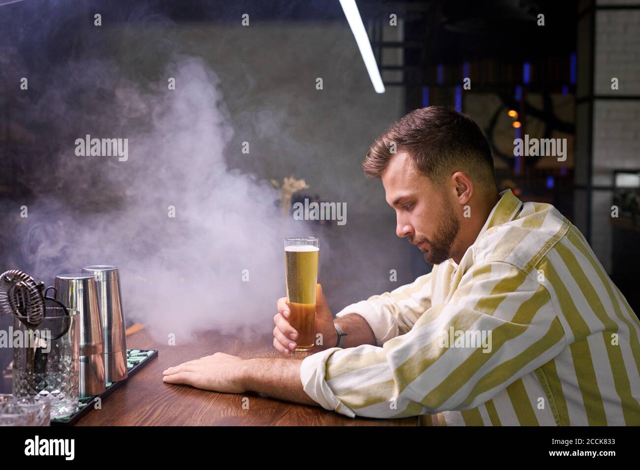 people, loneliness, alcohol concept. sad single young man drinking ...