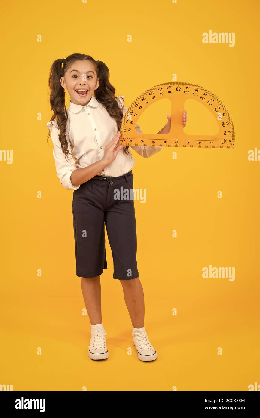 Schoolgirl holding protractor for lesson. Little child preparing for ...
