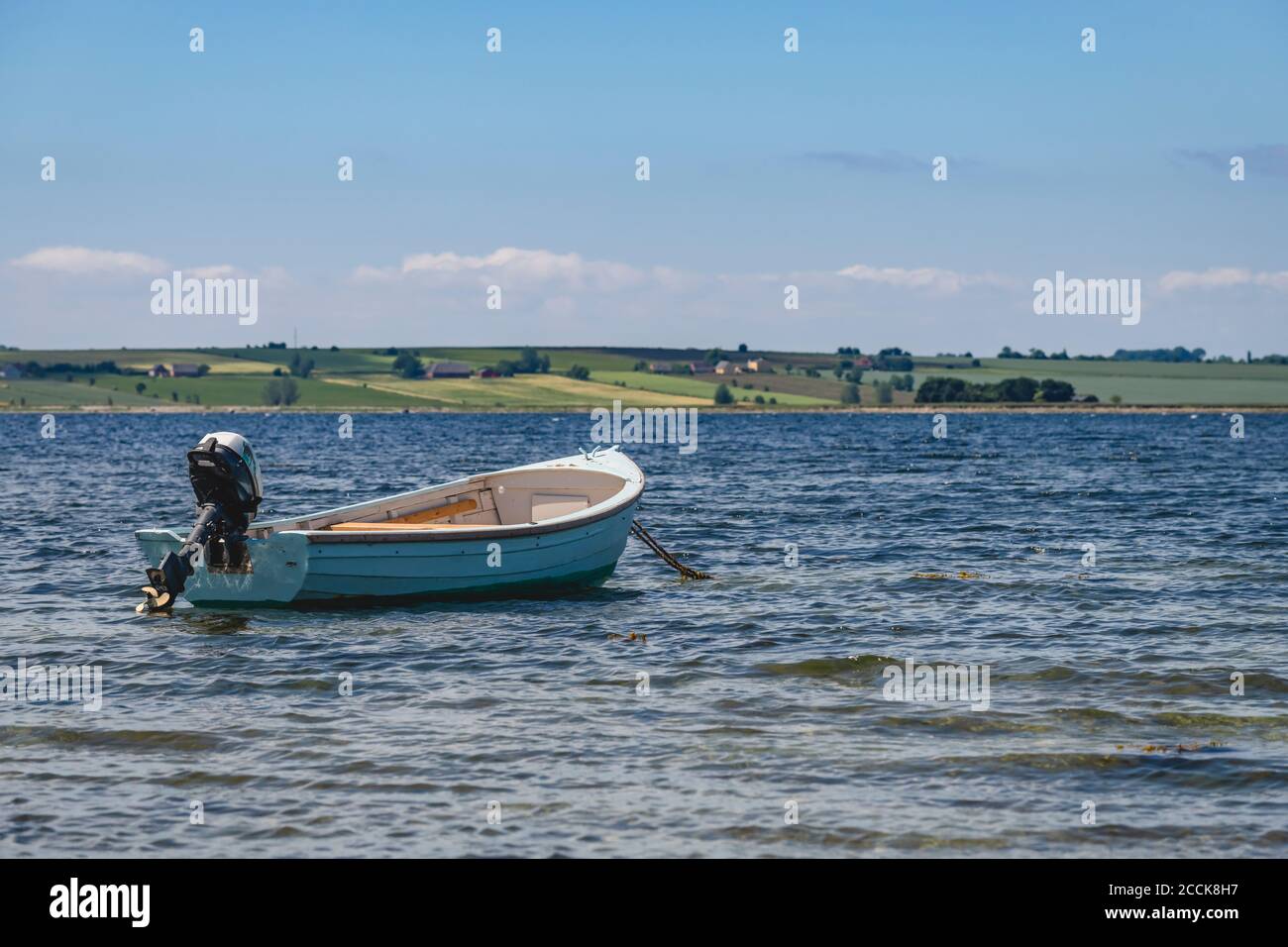Empty motorboat floating in coastal water Stock Photo - Alamy