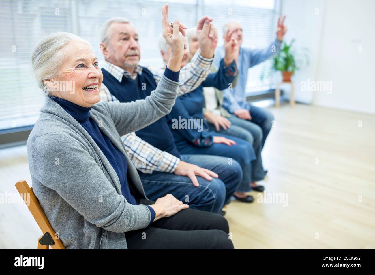 Senior citizens participating in group event in retirement home Stock ...