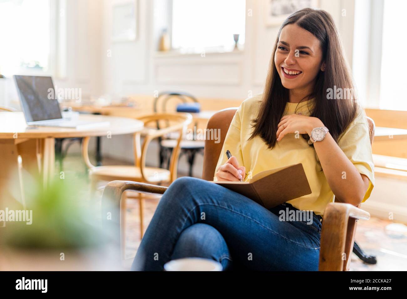 Person sitting on chair hi-res stock photography and images - Alamy