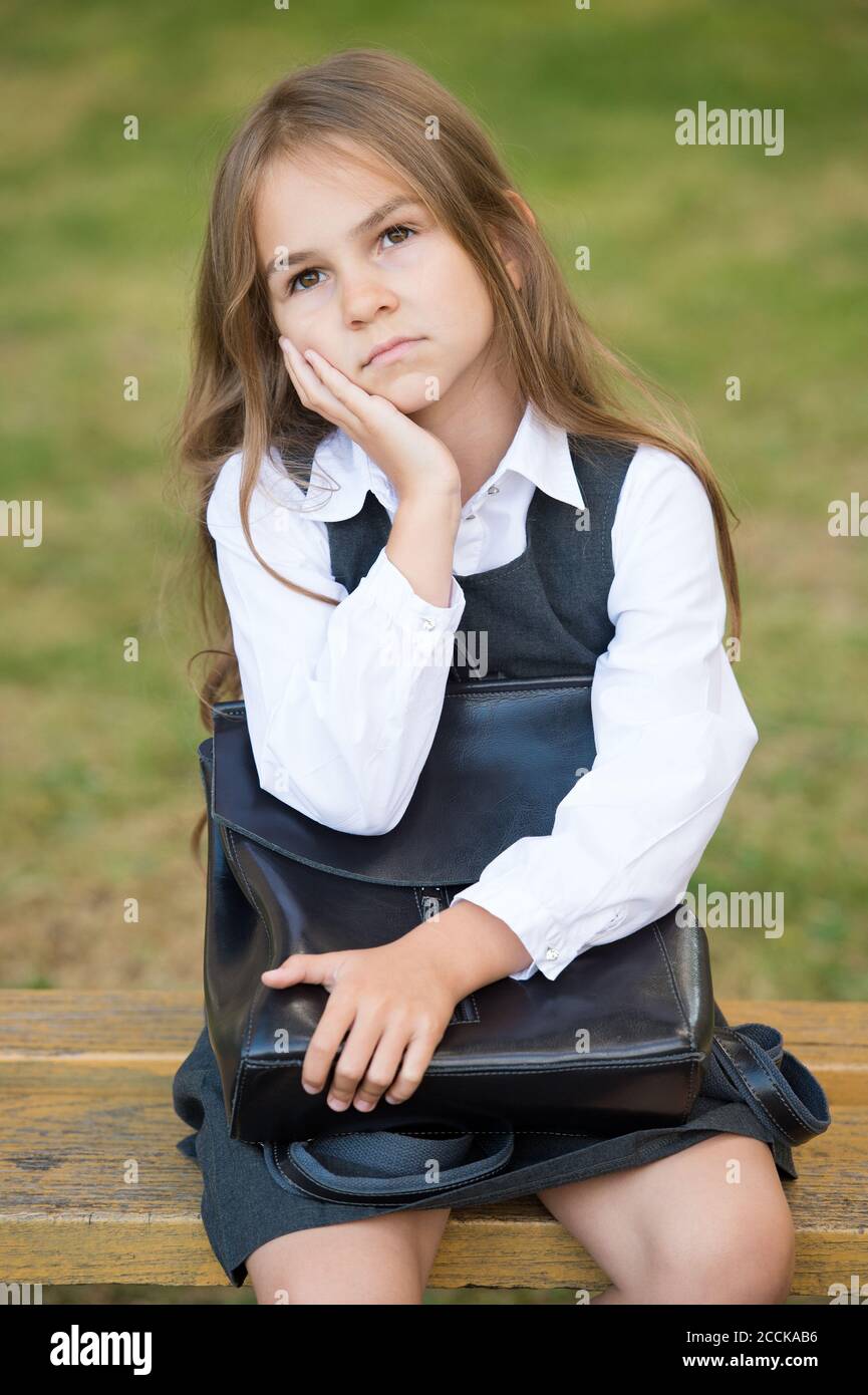 Learn to think. Serious child with thoughtful look. Small pupil lost in ...