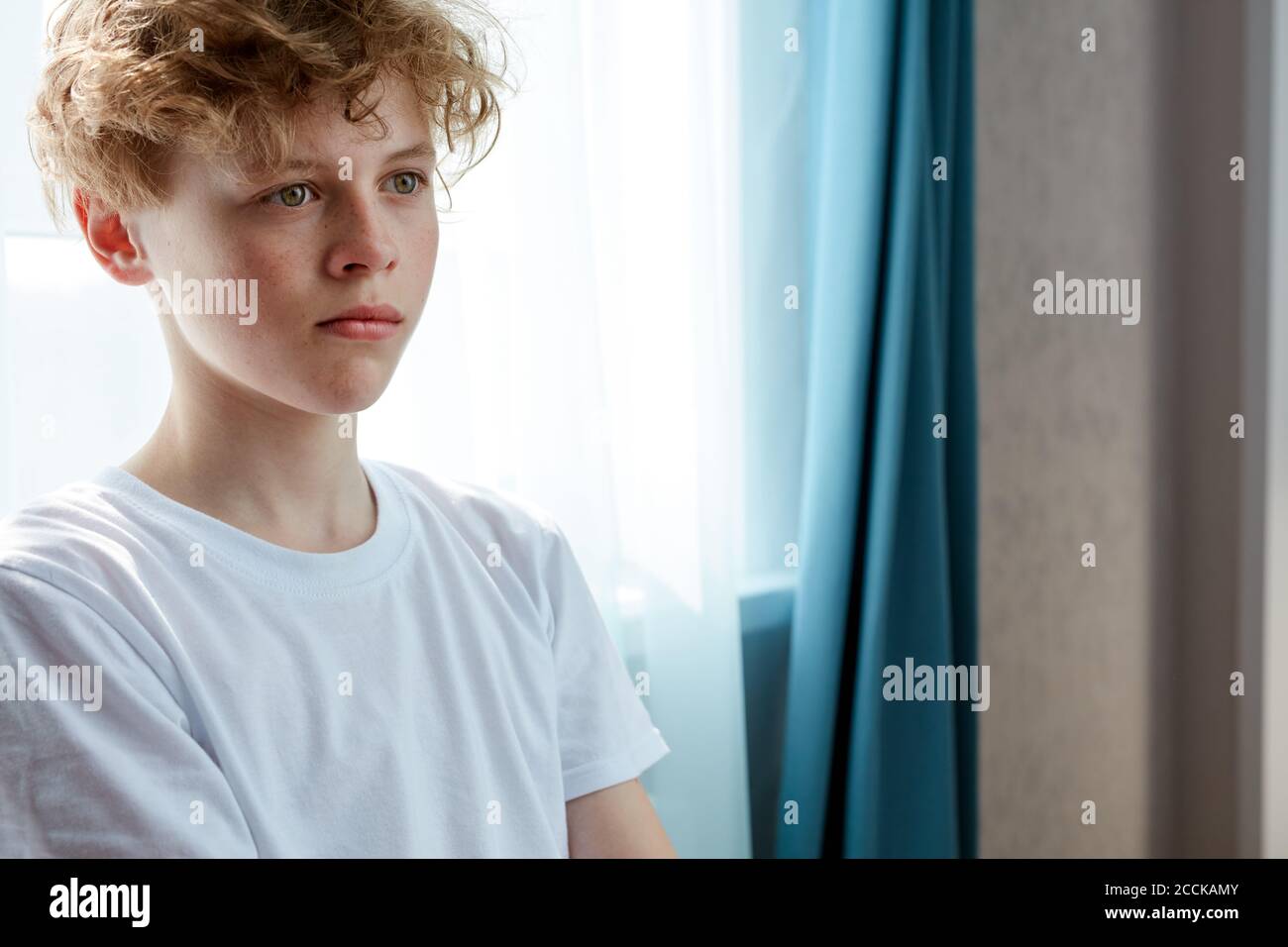 portrait of thoughtful serious boy with natural red hair, boy in ...