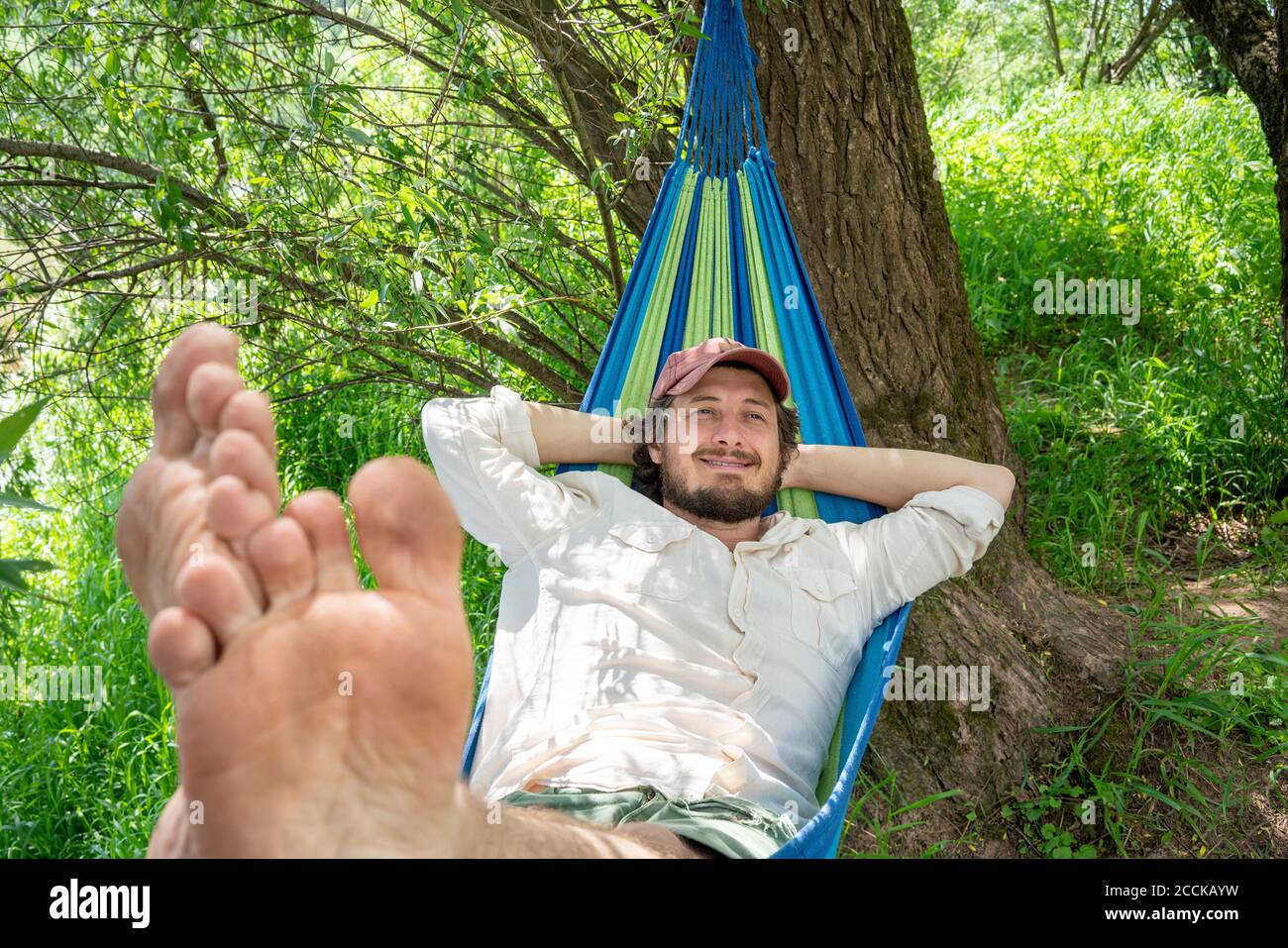 Man relaxing on hammock in the forest Stock Photo - Alamy