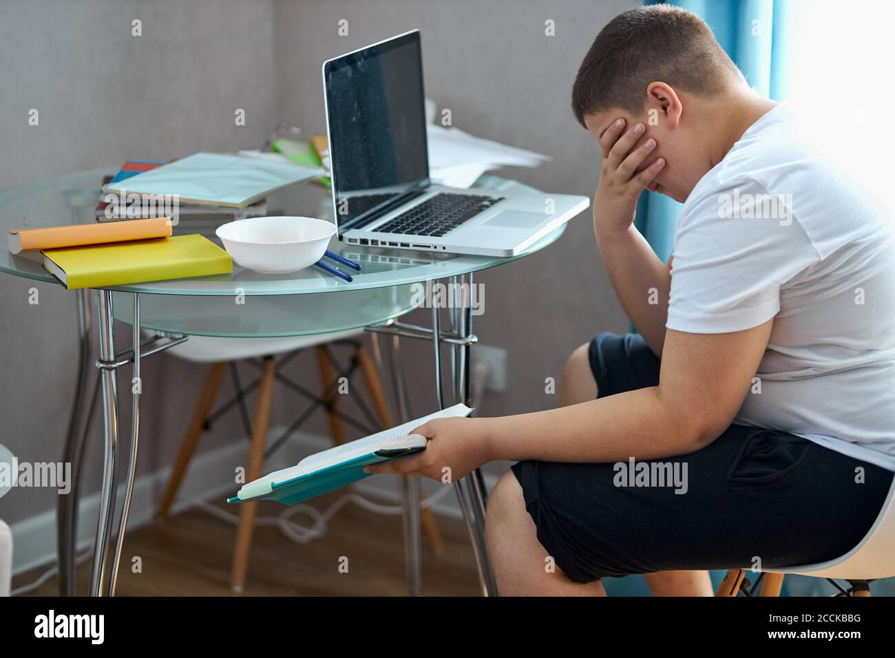 school boy tired to study, to do homework at home, sit depressed and ...