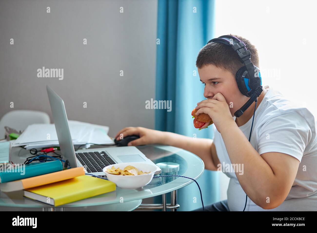passive boy always sits with laptop, playing computer games after ...