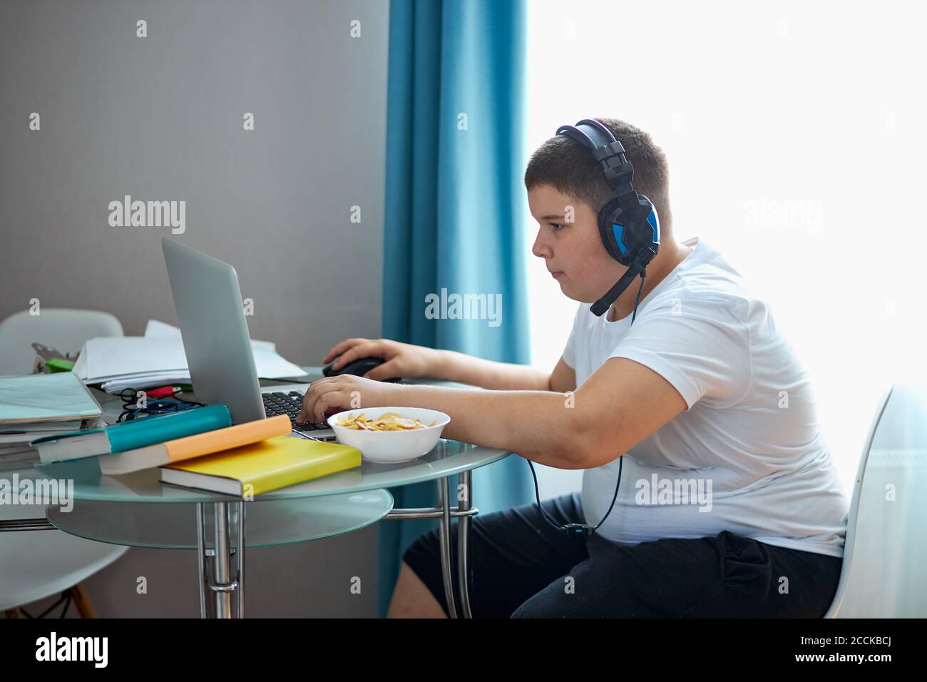 passive boy always sits with laptop, playing computer games after ...