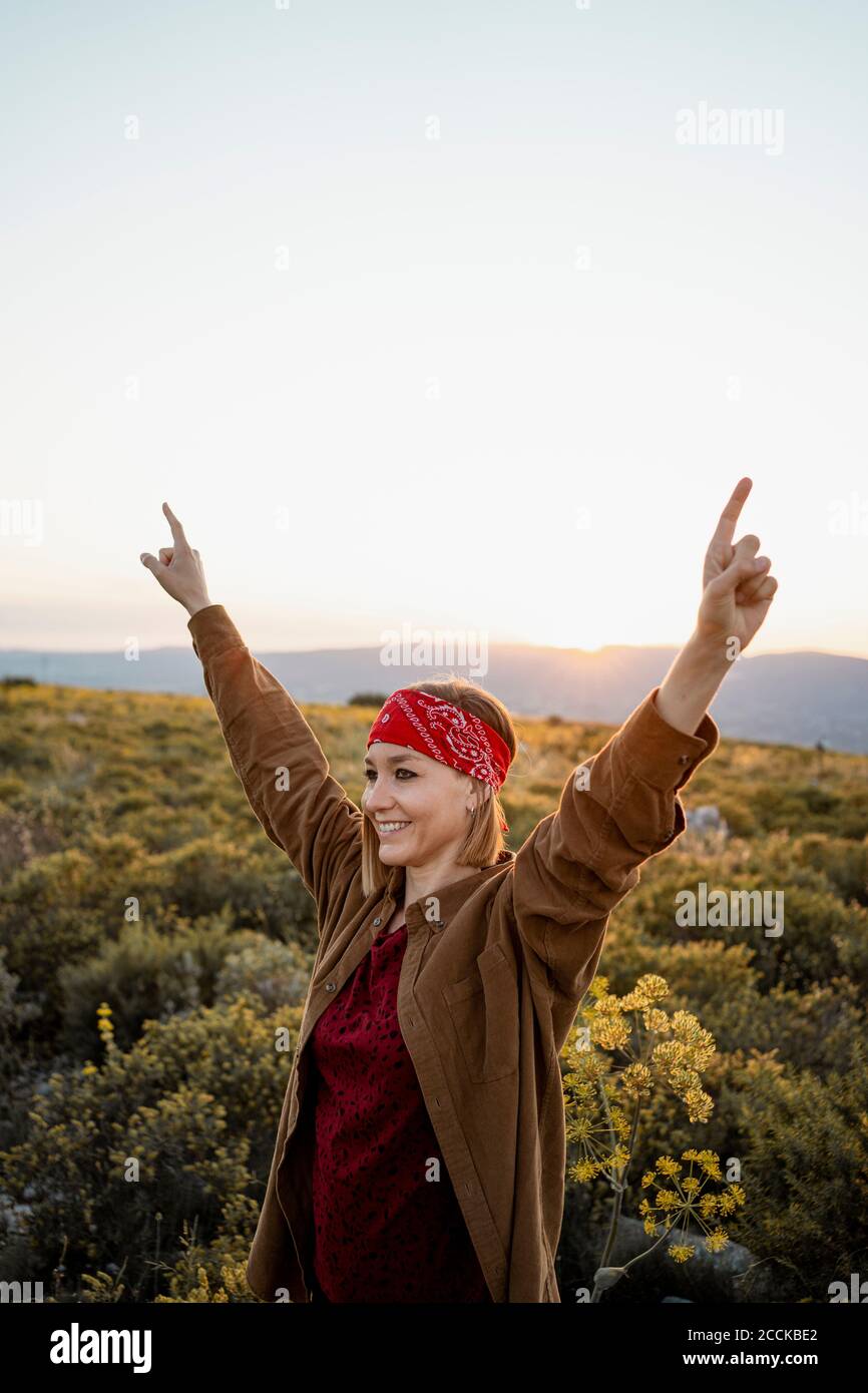 Happy woman raising arms in hi-res stock photography and images - Alamy