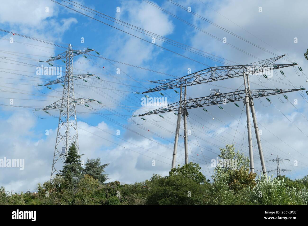 Group of electric pylons, high voltage lines. Overhead cables carrying ...