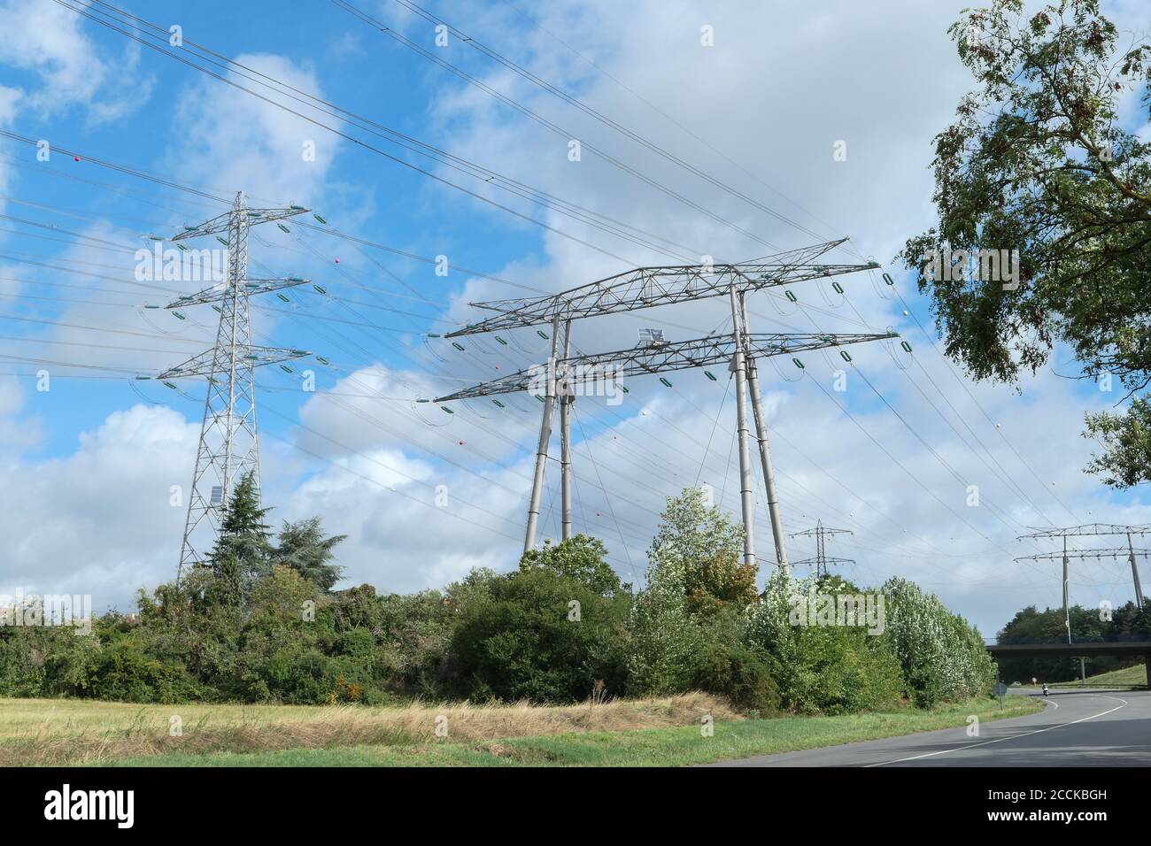 Group of electric pylons, high voltage lines. Overhead cables carrying ...