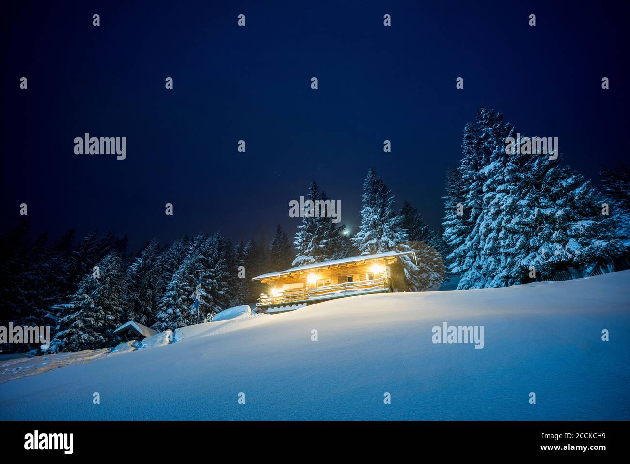 Illuminated mountain hut at night Stock Photo - Alamy