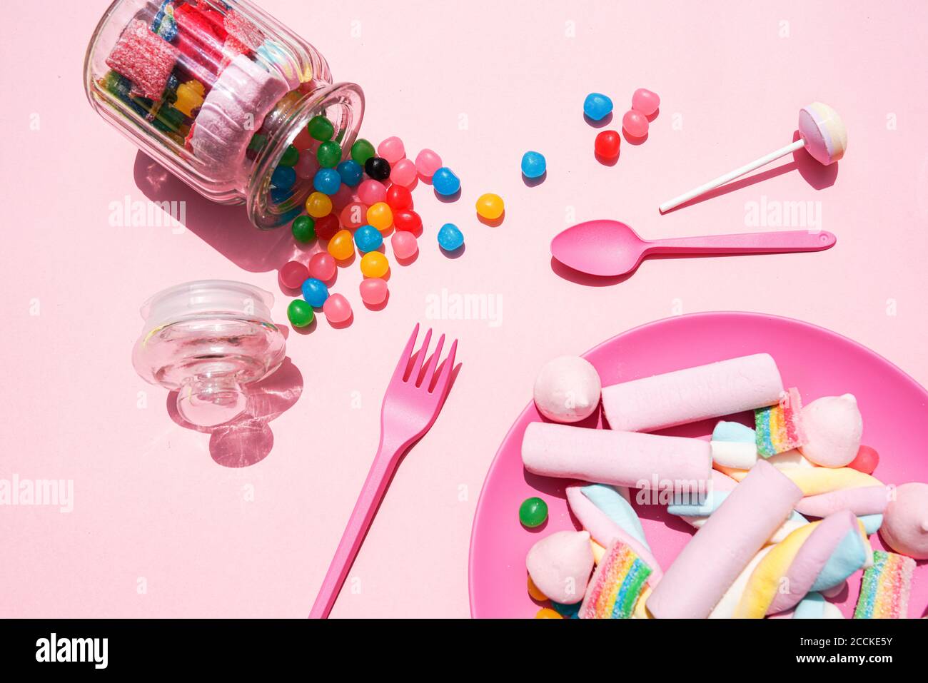 Studio shot of plastic plate filled with various sweets and candies ...