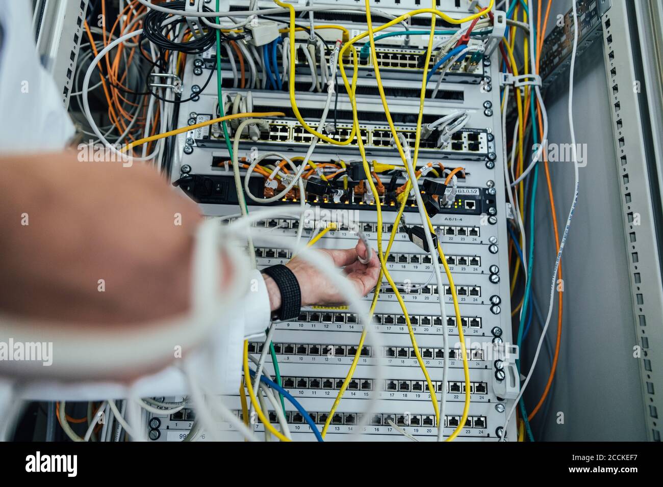 Close-up of mature man hand plugging cable in data center rack Stock ...