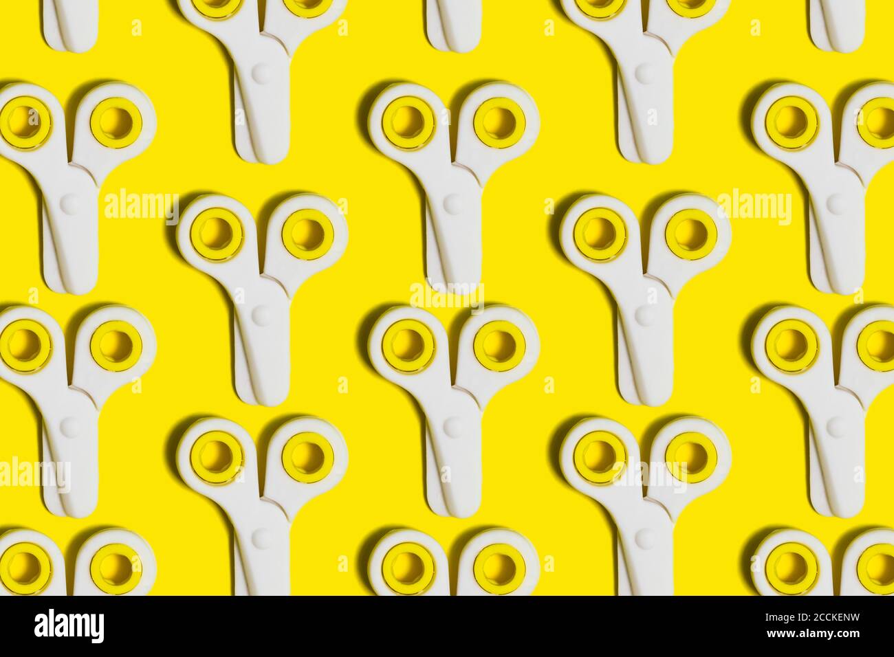 Pattern of rows of school scissors against yellow background Stock ...