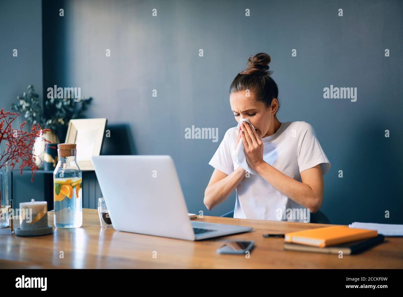 Woman sitting at desk cold hi-res stock photography and images - Alamy
